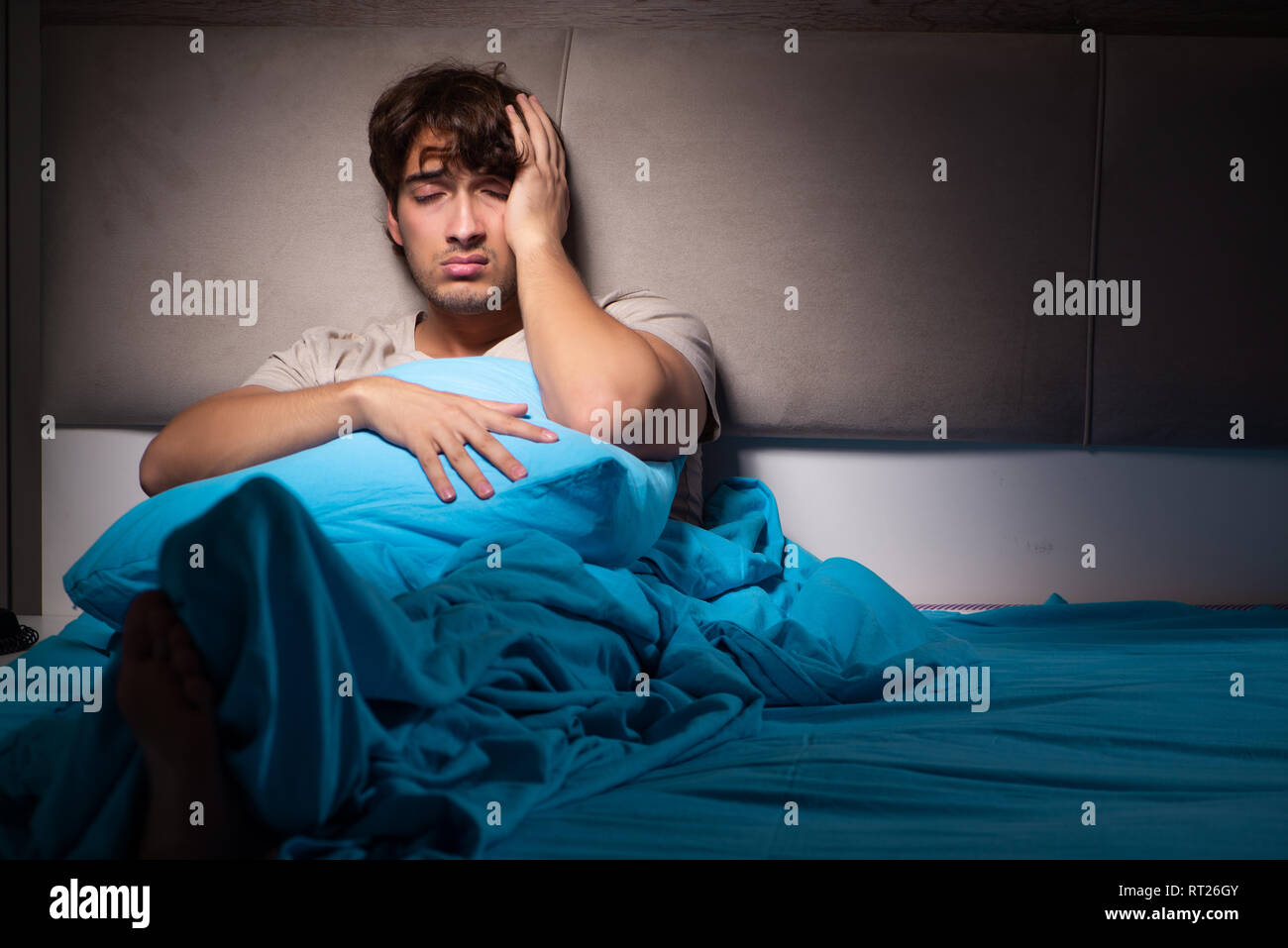 Tired exhausted man sleeping in his bed Stock Photo - Alamy