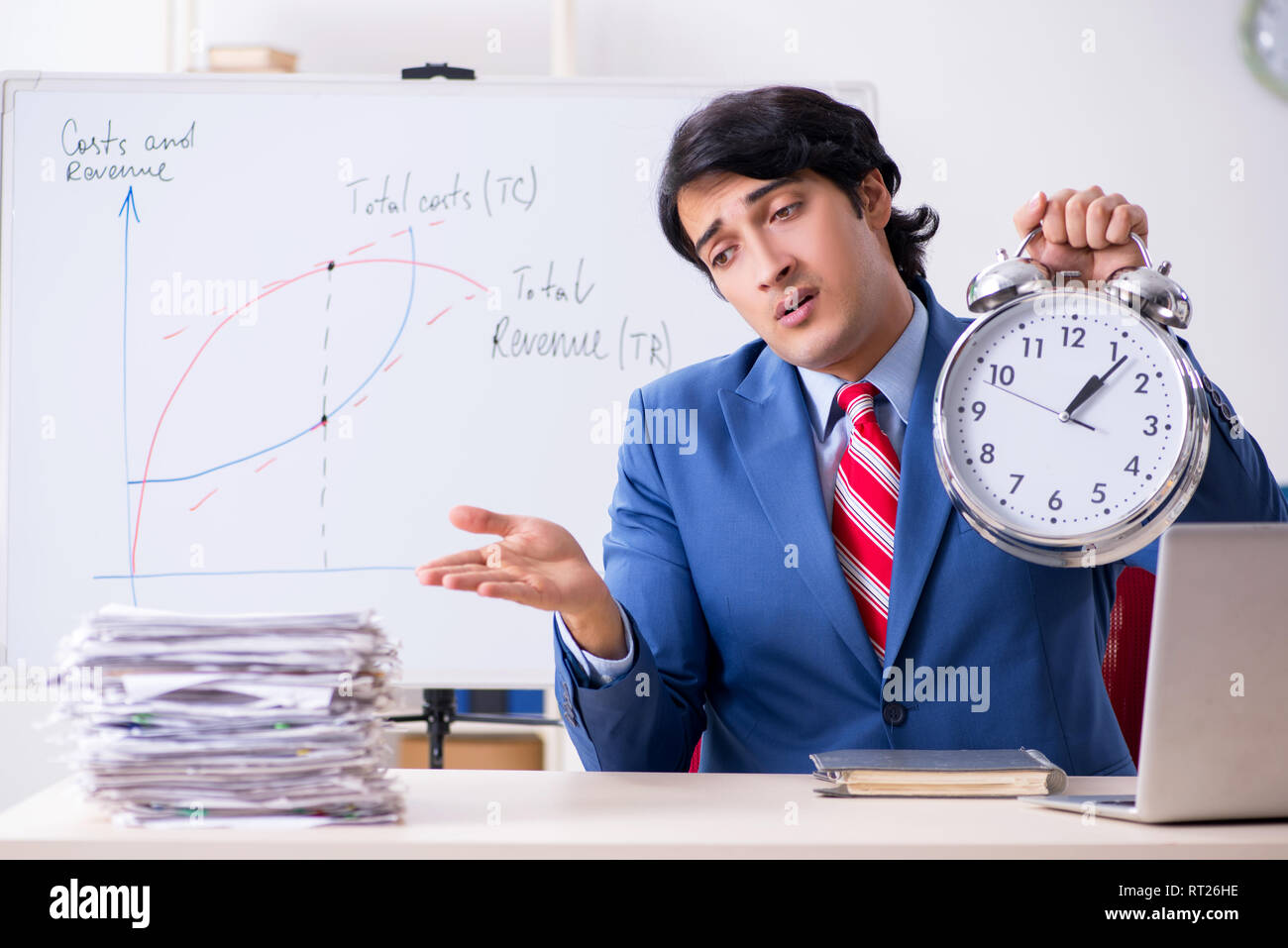 Busy businessman explaining business charts Stock Photo - Alamy