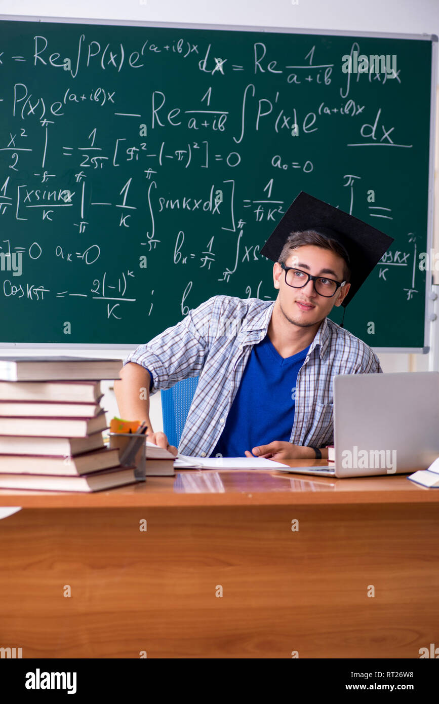Young male student studying math at school Stock Photo - Alamy
