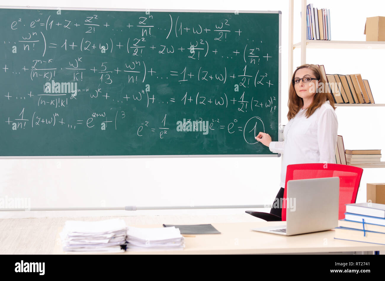 Female math teacher in the classroom Stock Photo - Alamy