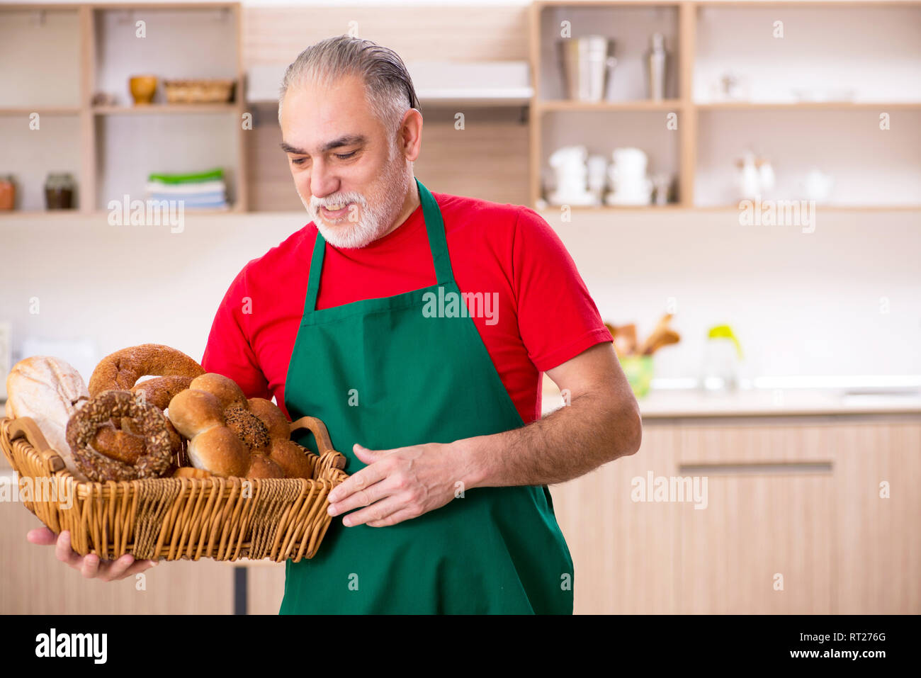 Old male baker working in the kitchen Stock Photo - Alamy