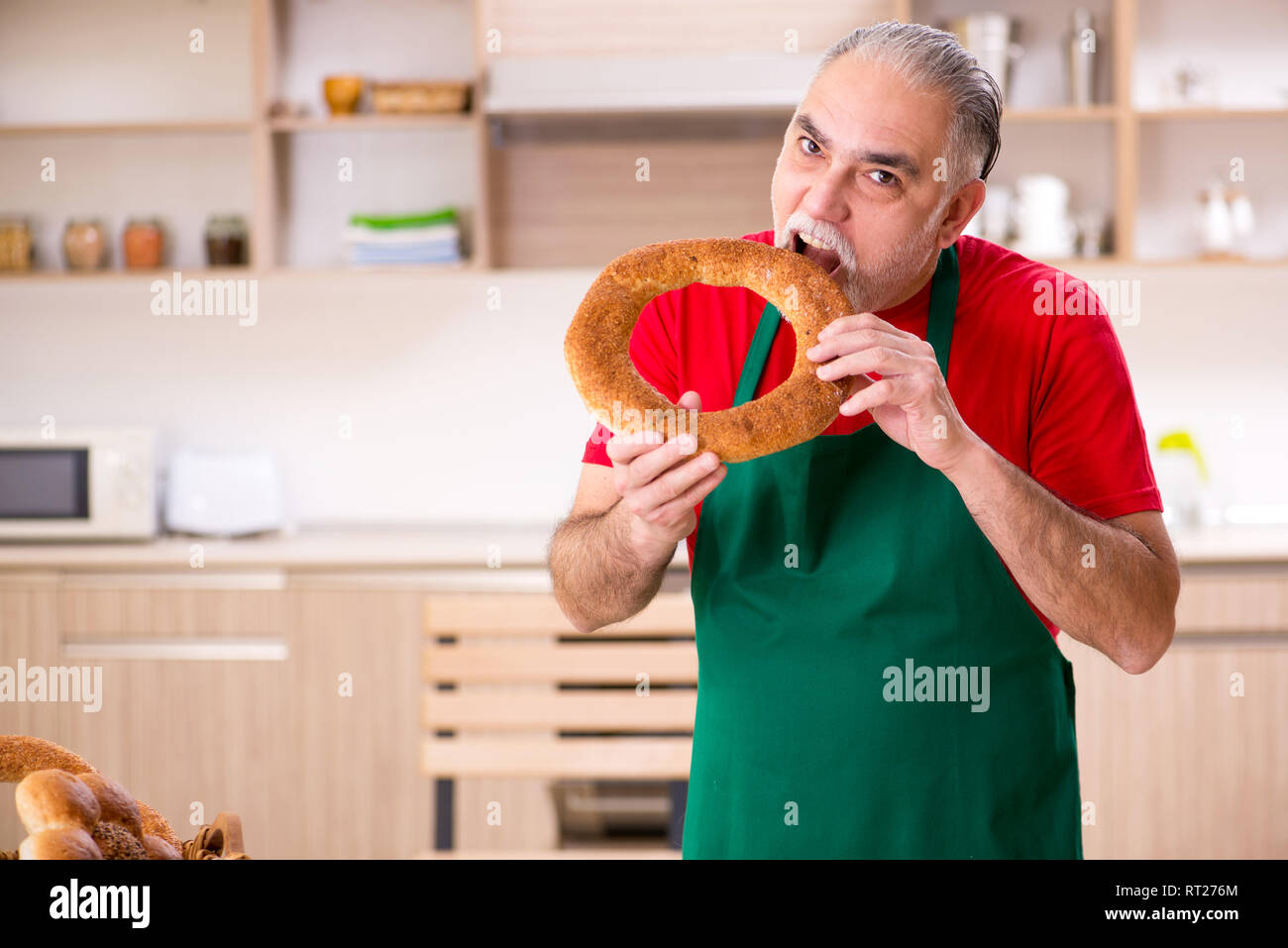 Old male baker working in the kitchen Stock Photo - Alamy