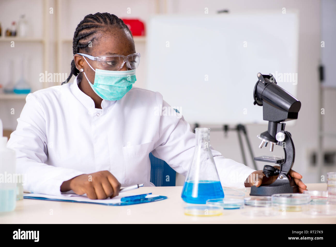 Young black chemist working in the lab Stock Photo - Alamy