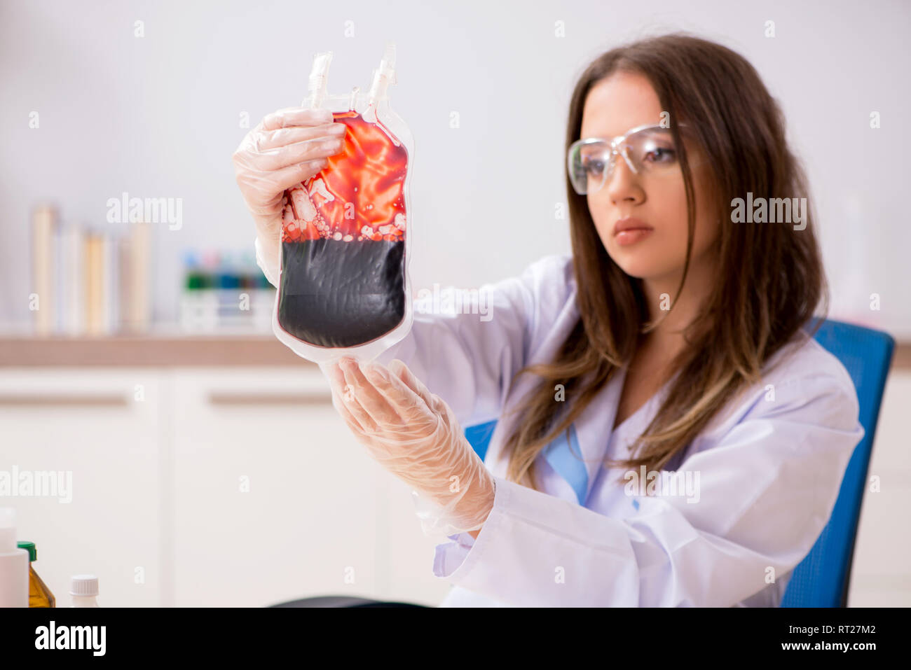 Female assistant with bag of blood in the lab Stock Photo - Alamy