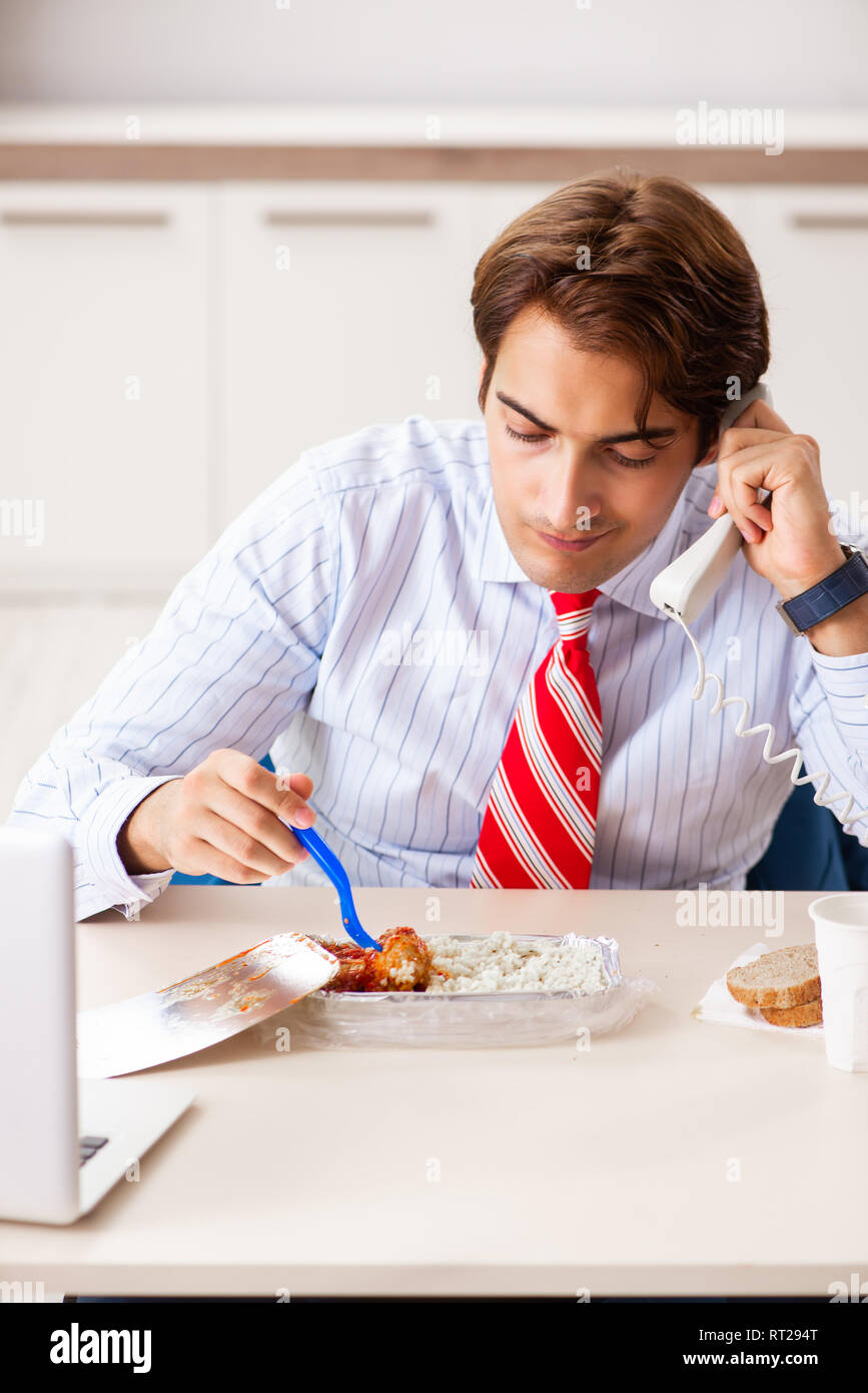 Man having meal at work during break Stock Photo - Alamy