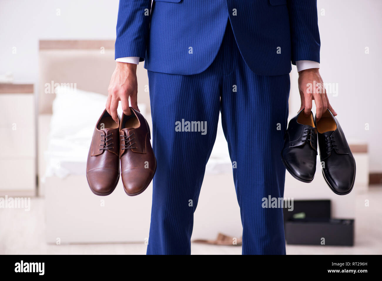 Young handsome businessman choosing shoes at home Stock Photo - Alamy
