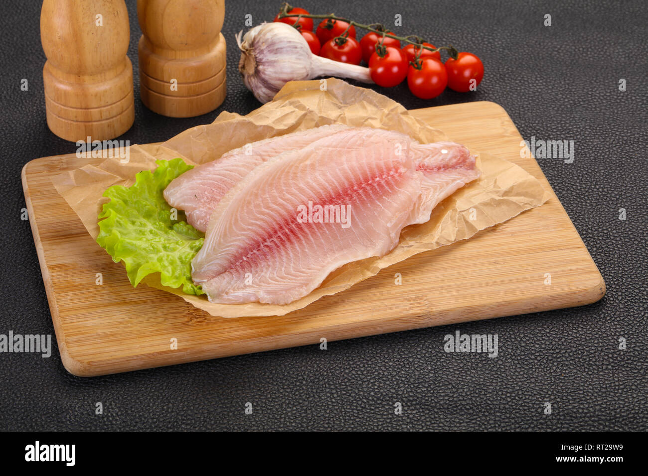 Raw tilapia fish ready for cooking Stock Photo - Alamy