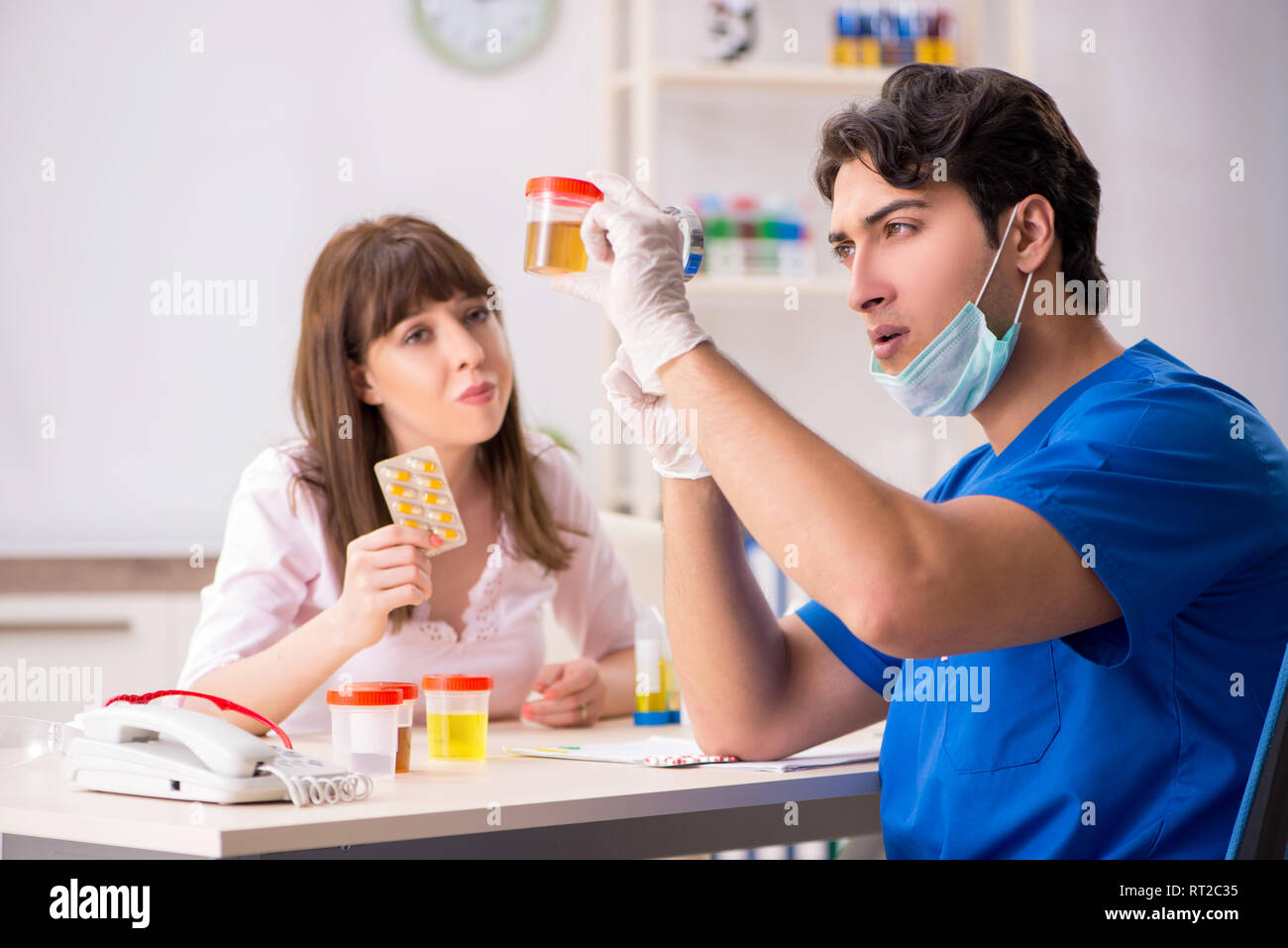 Patient visiting doctor for urine test Stock Photo - Alamy