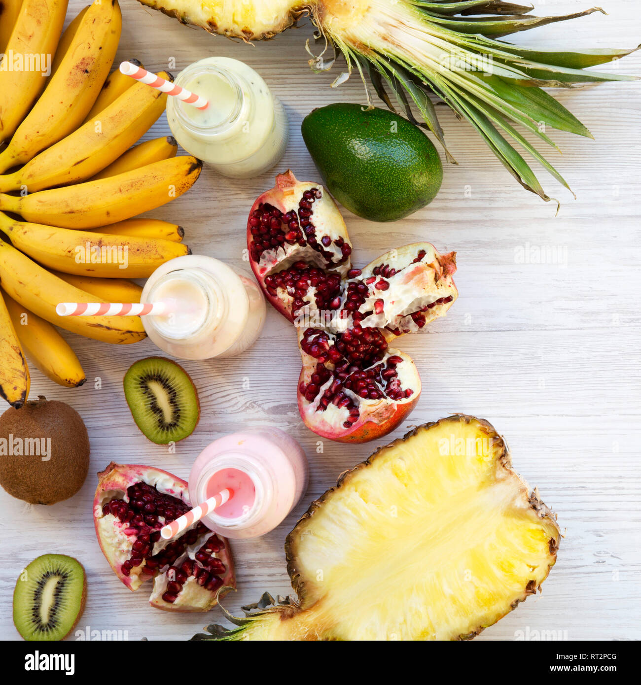Fruit smoothies of different tastes in glass bottles with ingredients ...