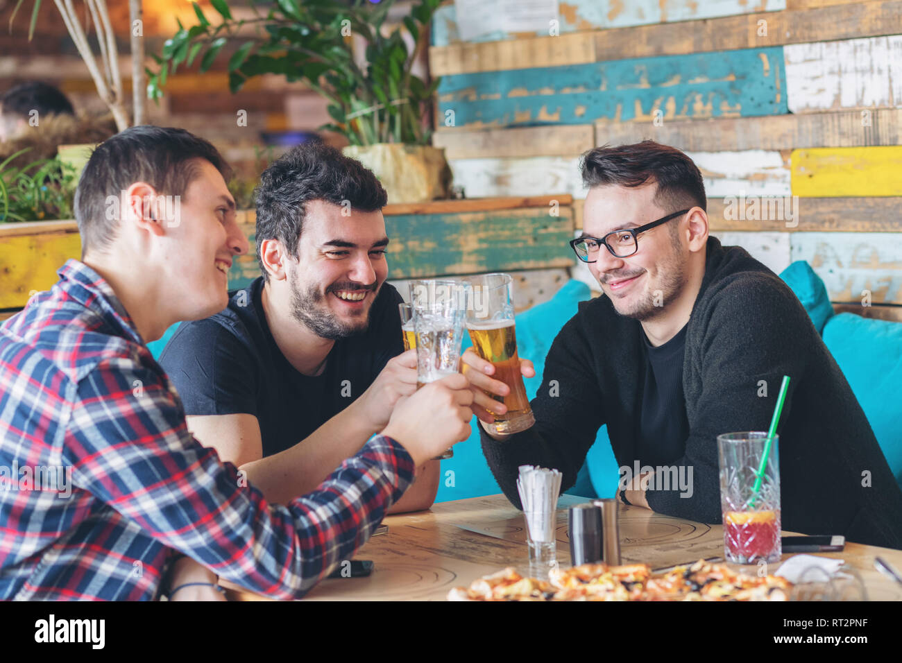 Happy men friends drinking beer at brewery bar restaurant Stock Photo ...