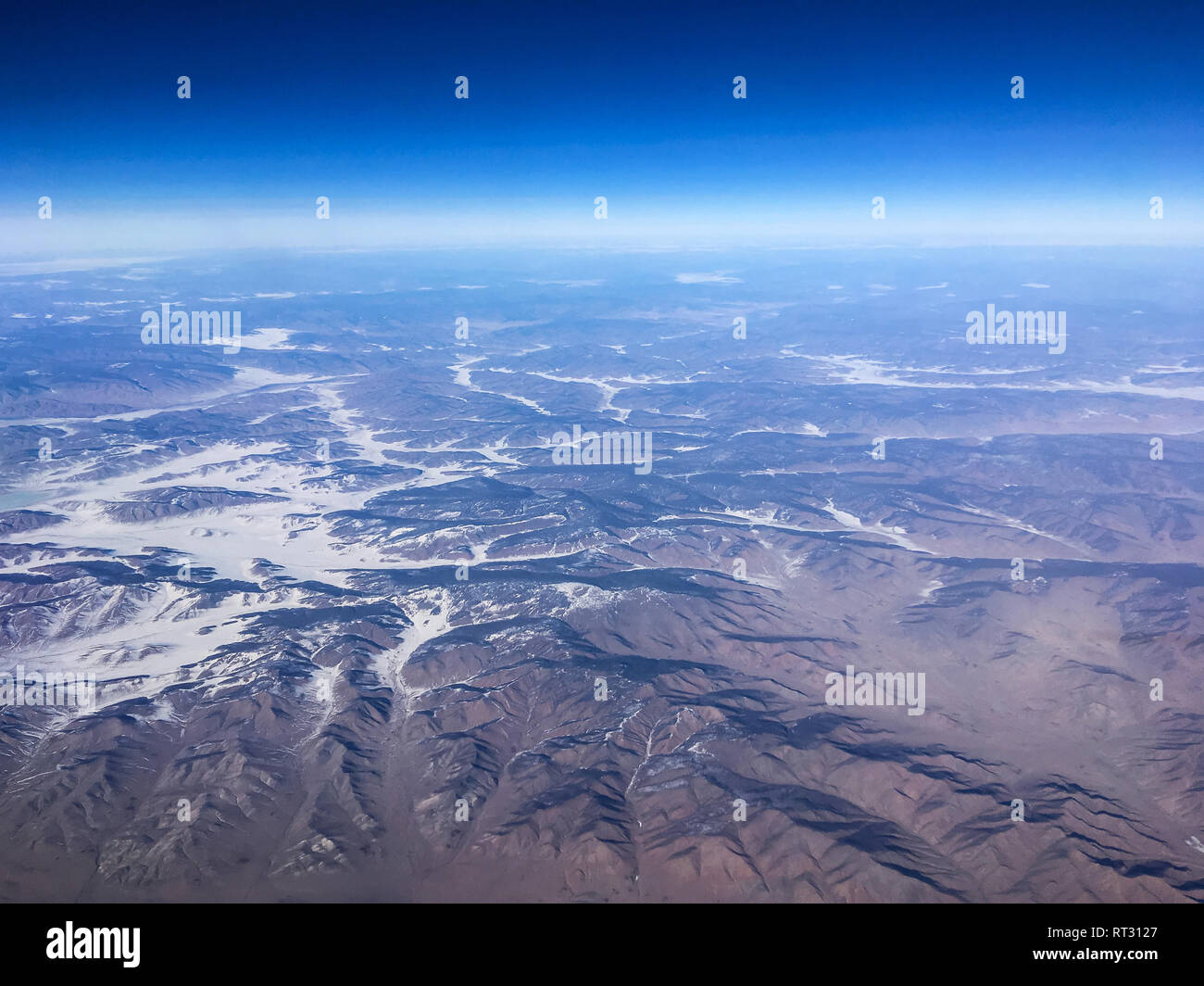An aerial view of Chinese mountains from the airplane flying high above ...