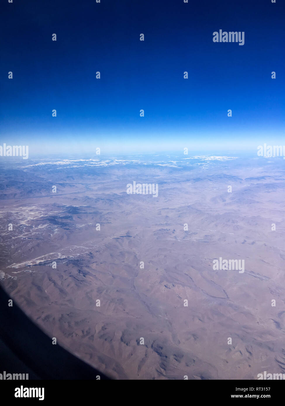 An aerial view of Chinese mountains from the airplane flying high above ...