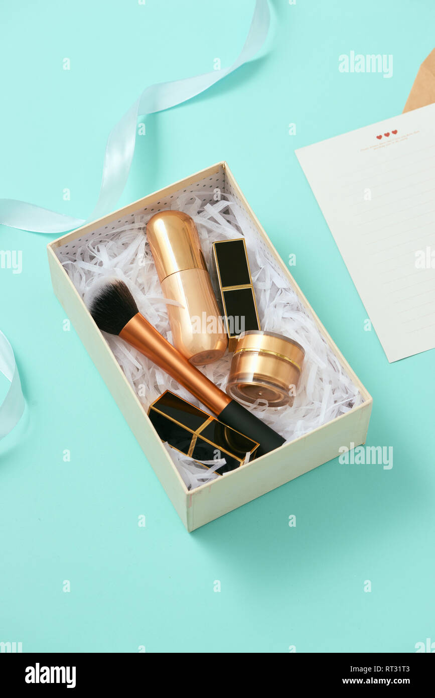 Make up gift box with serum, blush, brushes, cream and lipsticks ...