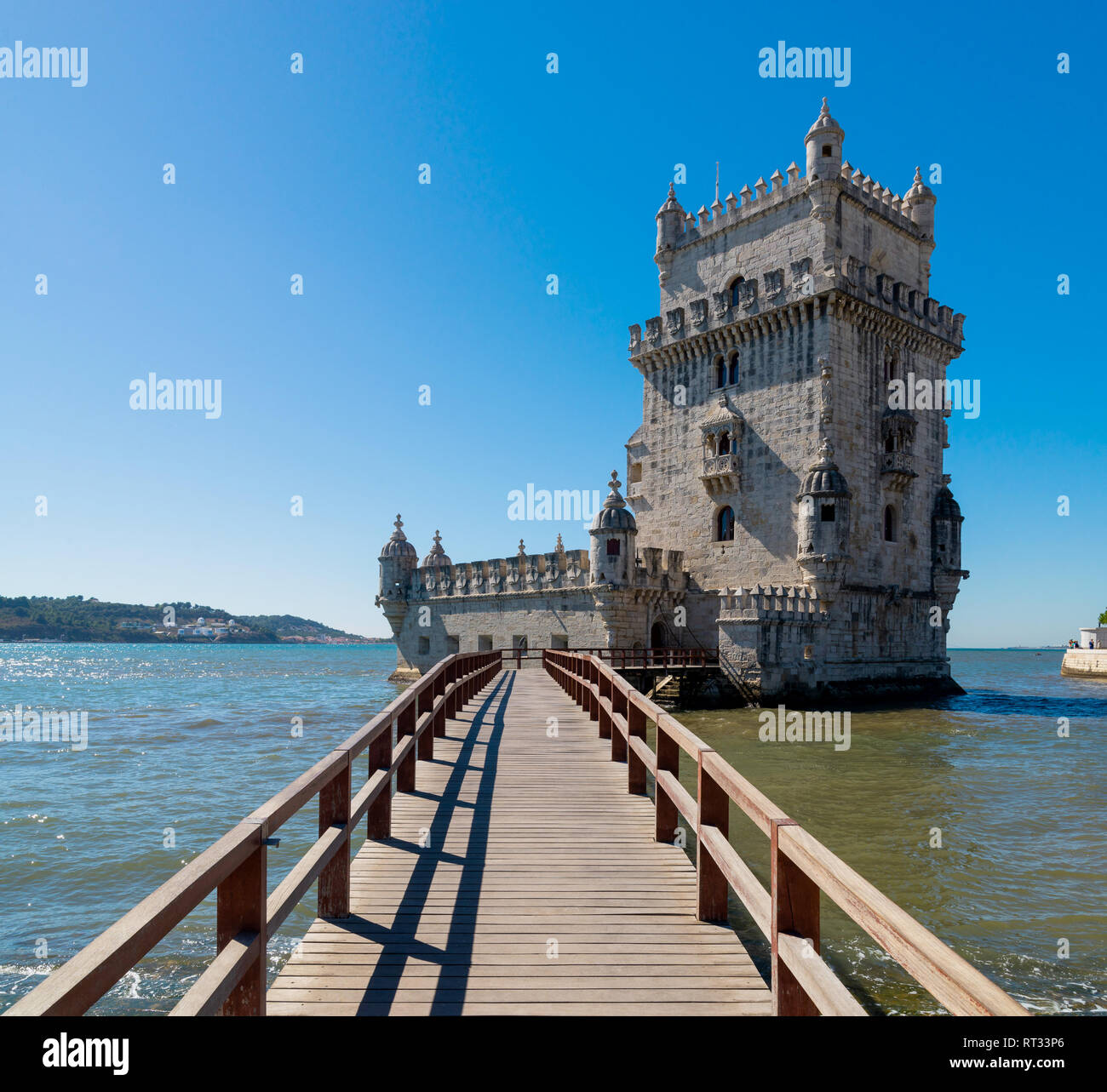 Scenic Belem Tower and wooden bridge miroring with low tides on Tagus ...