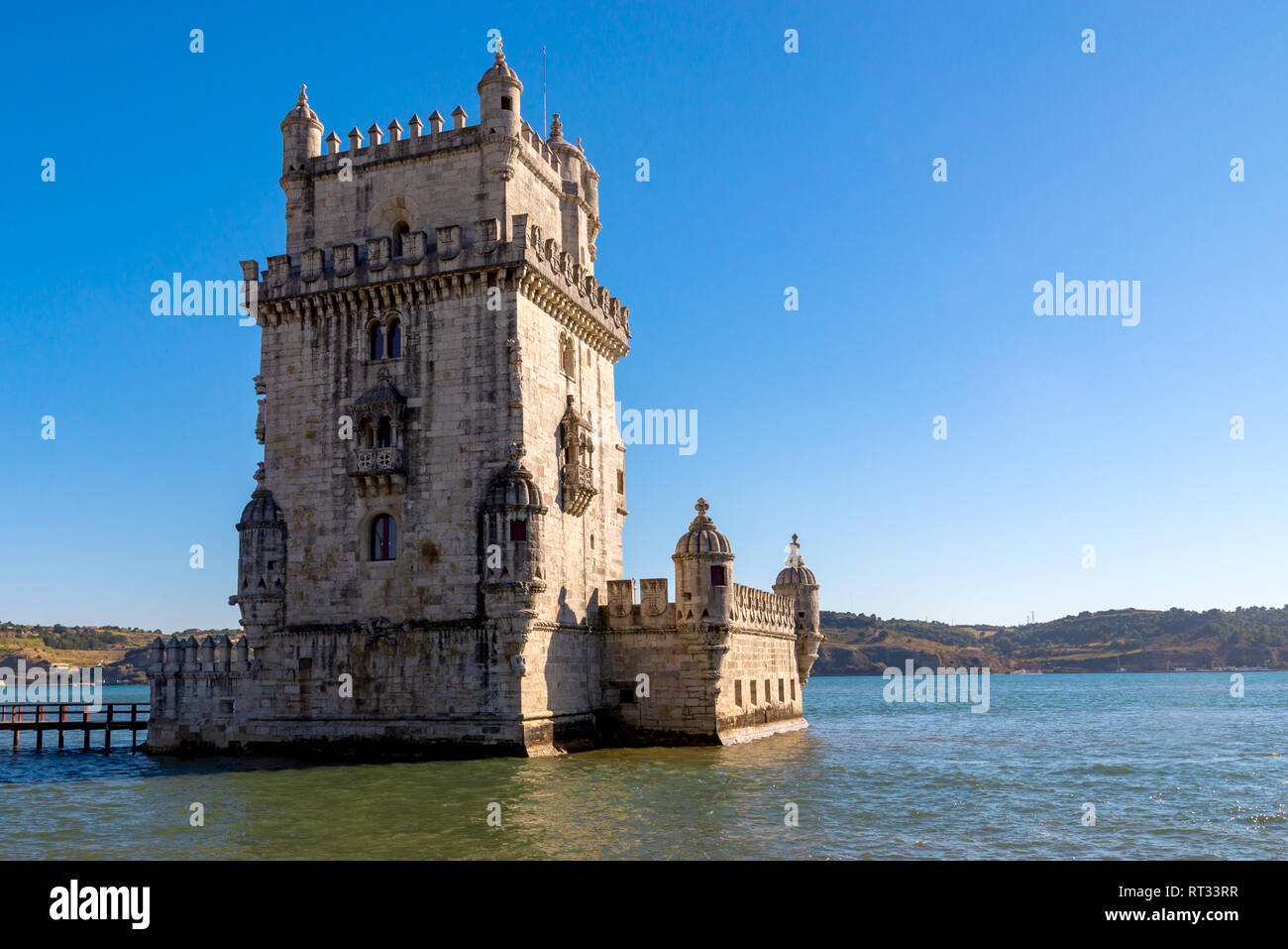 Scenic Belem Tower and wooden bridge miroring with low tides on Tagus ...