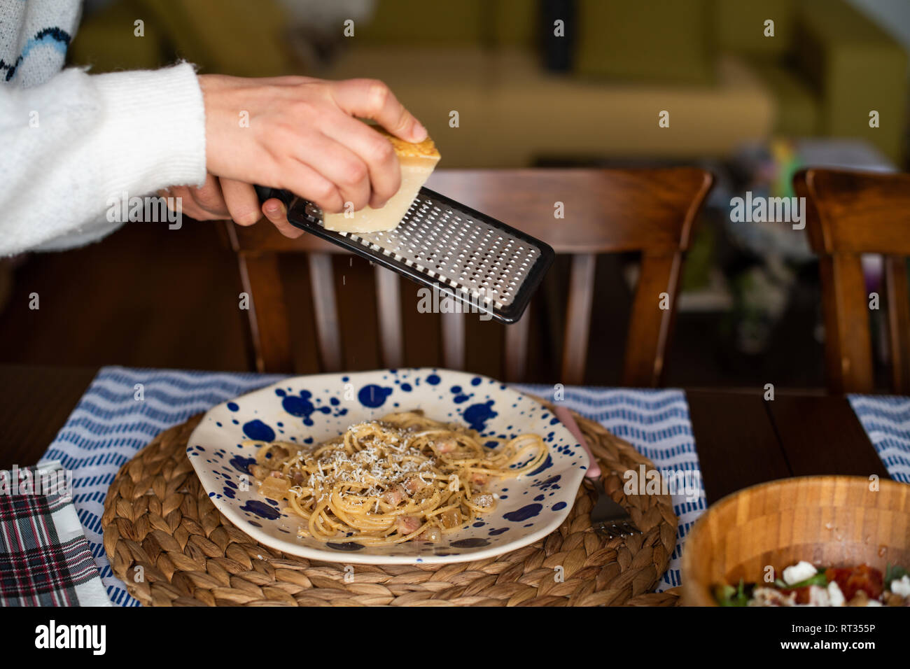 woman hands grating parmesan cheese on pasta carbonara Stock Photo - Alamy