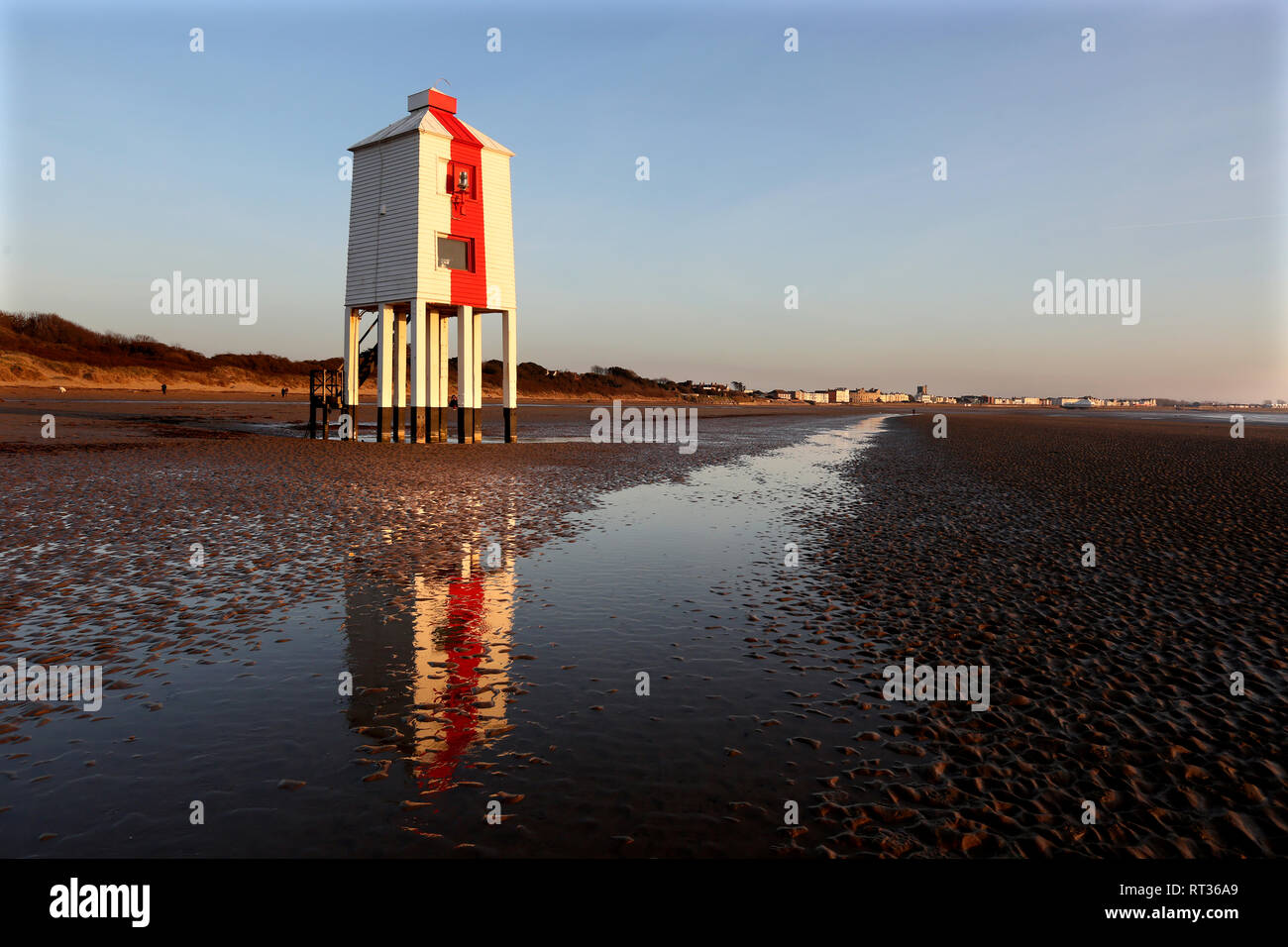 The low lighthouse at Burham-On-Sea, Somerset during the warm glow of ...