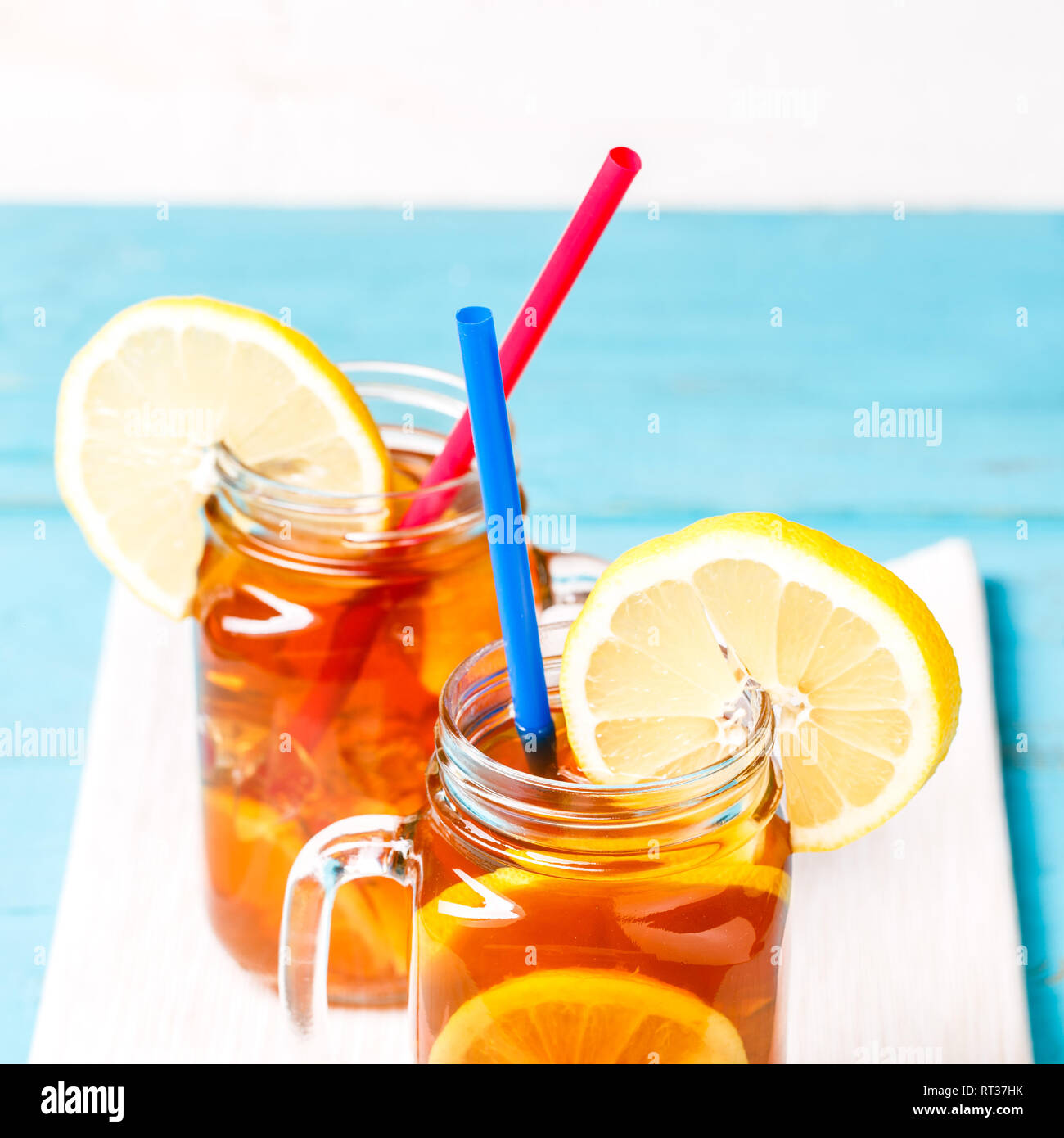Iced tea in a glass jar with lemon Stock Photo - Alamy