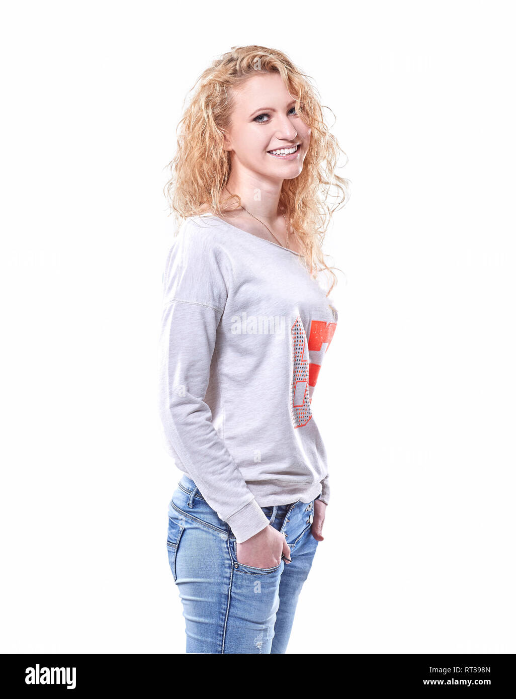 side view. cute young woman looking at camera Stock Photo - Alamy