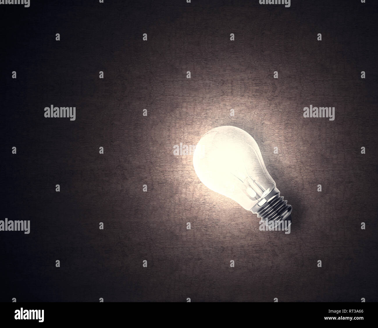 Lighting bulb with wooden texture background glowing in dark Stock ...