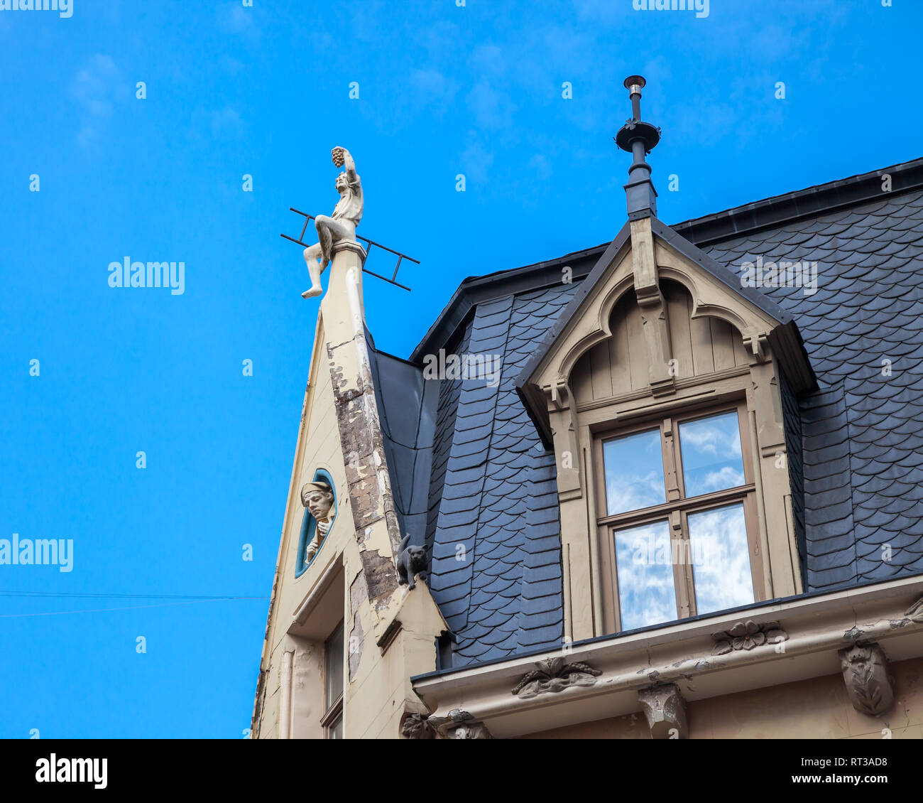 Old garret roof with sculptures and windows, Riga, Latvia Stock Photo ...