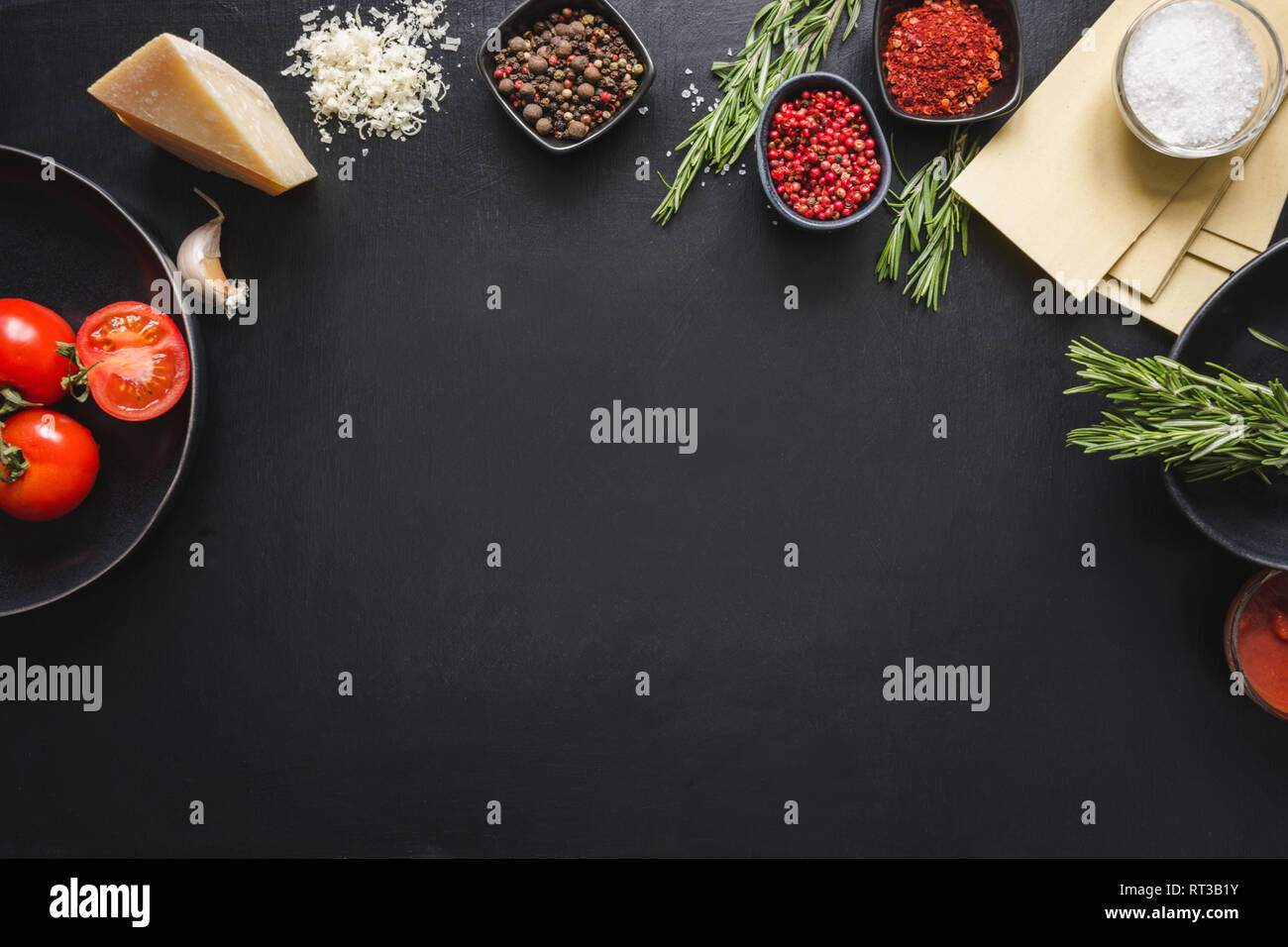 Raw ingredients for lasagna, pasta,vegetables and herbs on black ...