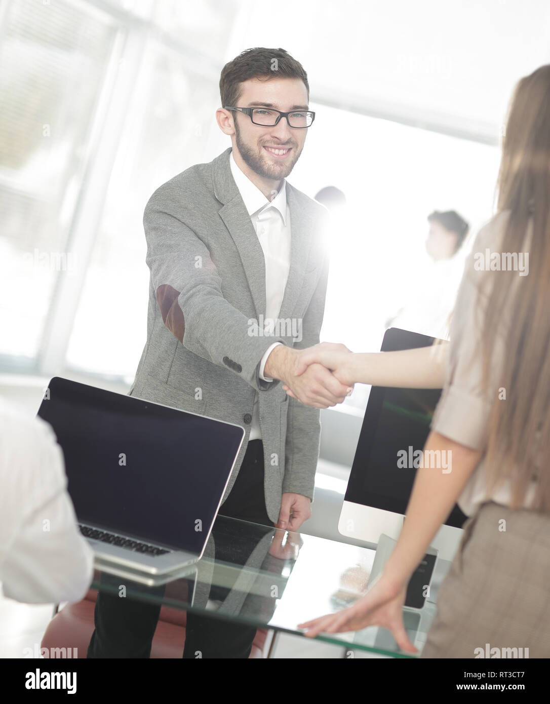 close up. the handshake of employee and customer in a modern office ...
