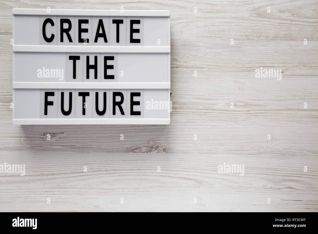 'Create the future' word on modern board on a white wooden surface, top ...