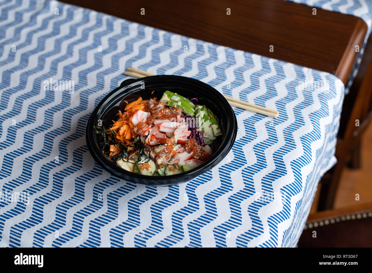 hawaii poke bowl with salmon, rice, surimi, avocado, tobiko, carrot and ...