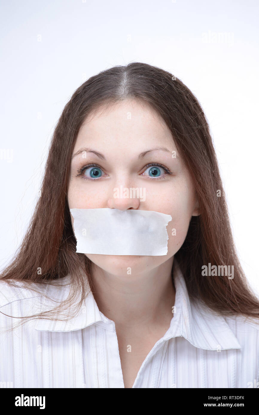 closeup. young business woman with a taped mouth. isolated a white ...
