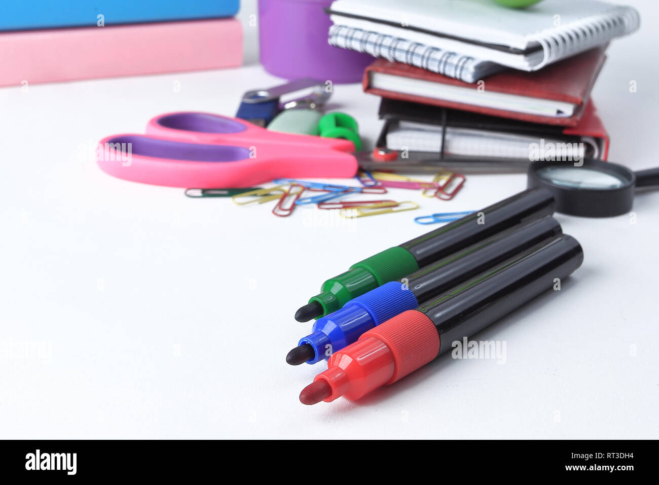 colored markers and school supplies on a white background .concept of ...