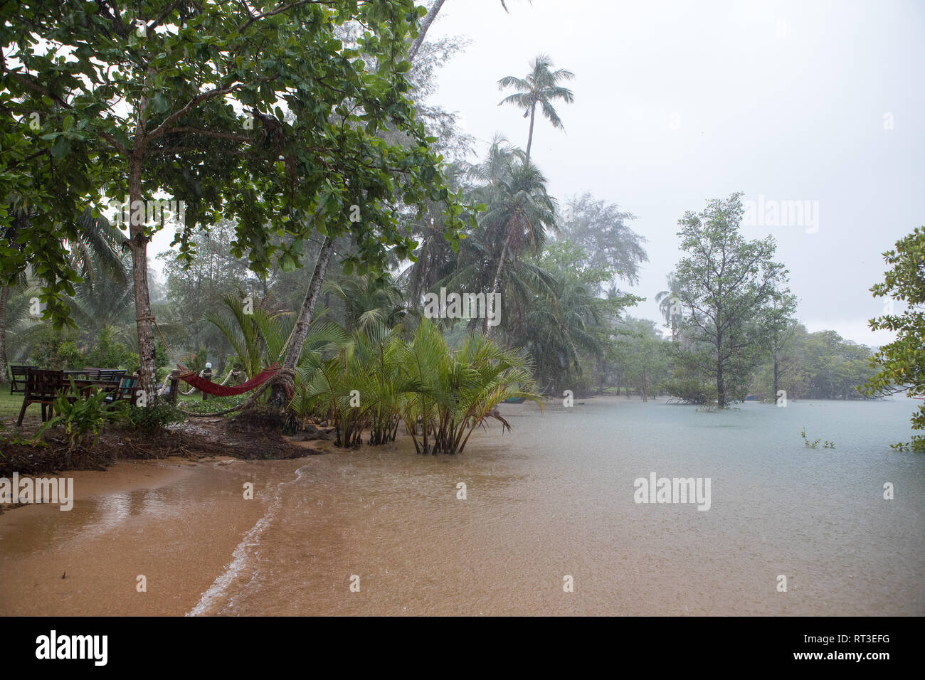 Heavy tropical rain and flooding on the beach Stock Photo - Alamy