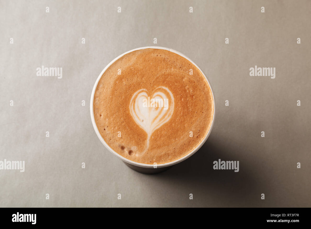 Craft cardboard cup of latte or cappuccino with patterned heart latte ...