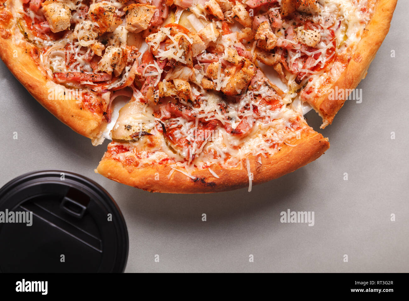 Hot cheese pizza and a Cup of coffee on a gray background, top view ...
