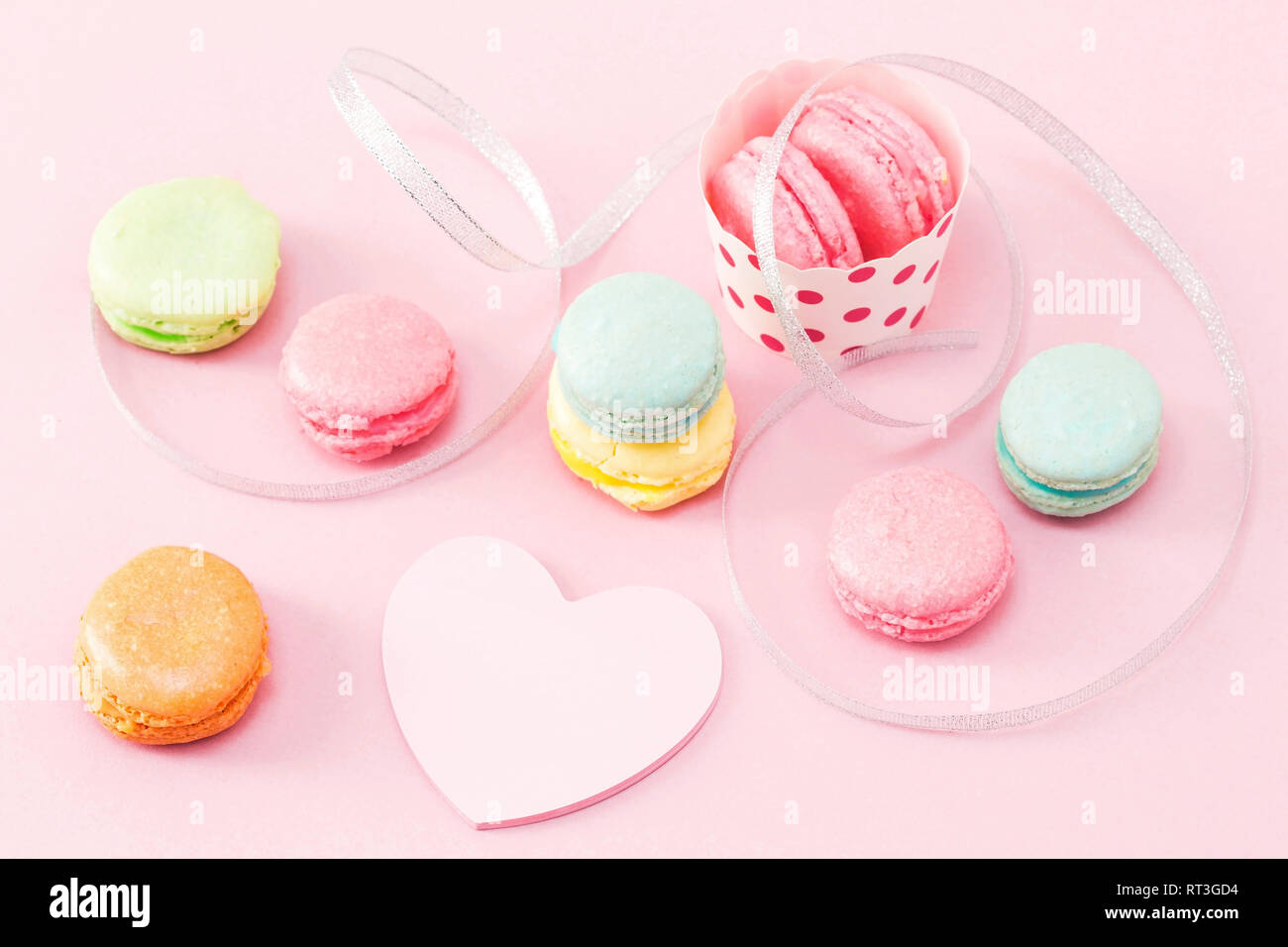 Colorful macaroons with the blank heart shape note and the silver ...