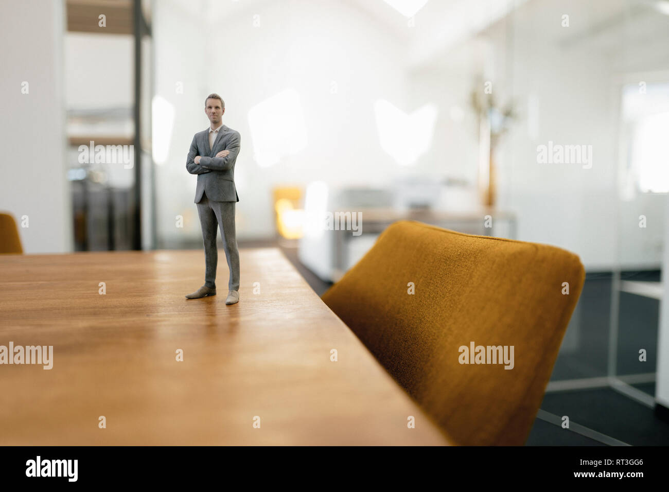 Businessman figurine standing on desk in modern office Stock Photo - Alamy