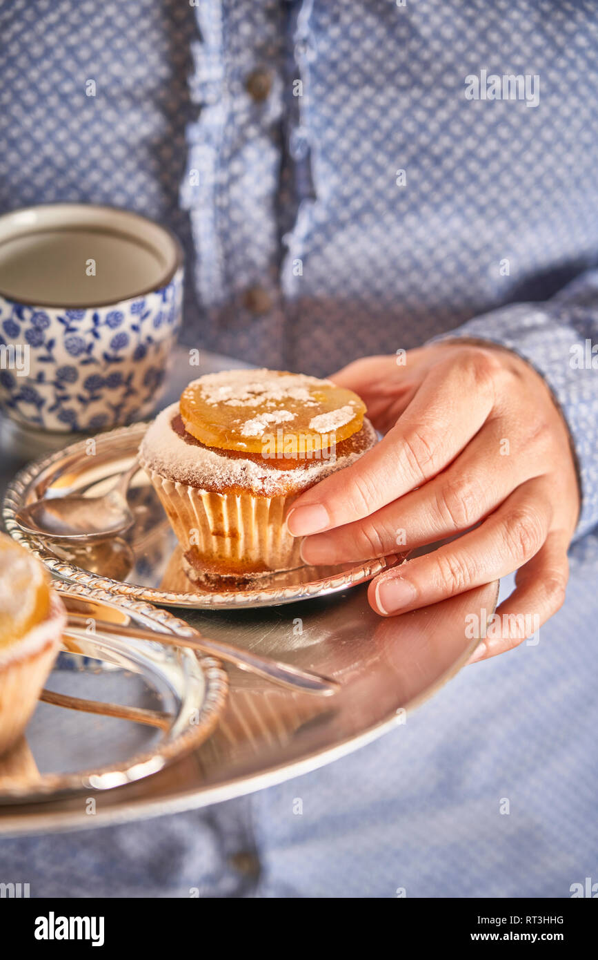 Womans hand holding muffin candied orange slice hi-res stock ...