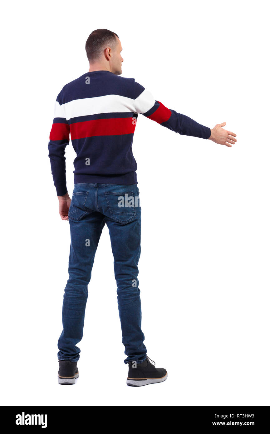 Back view of a man who stretches his hand for a handshake. Rear view ...