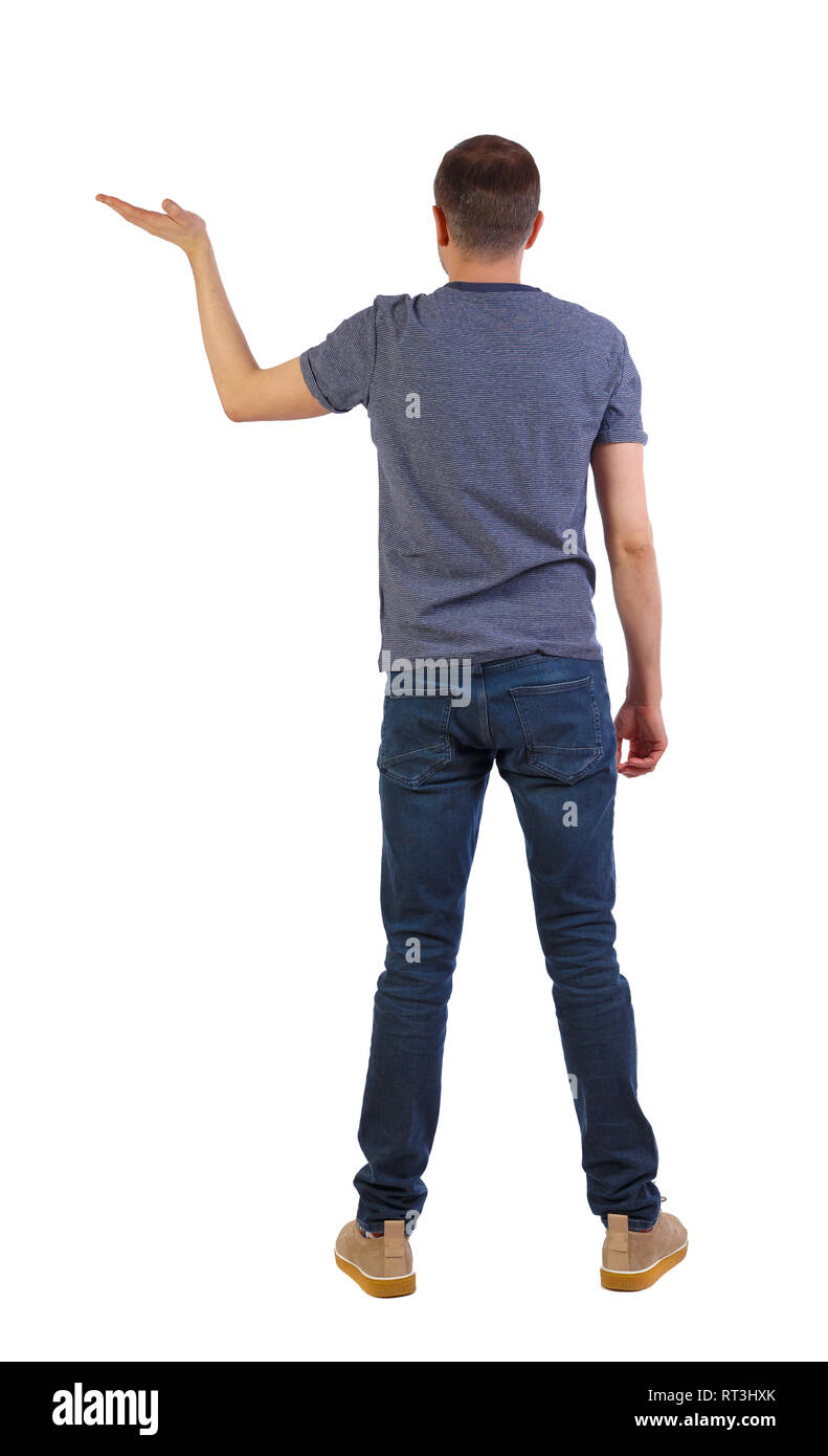 Back view of man looking at wall and Holds hand up. Rear view people ...