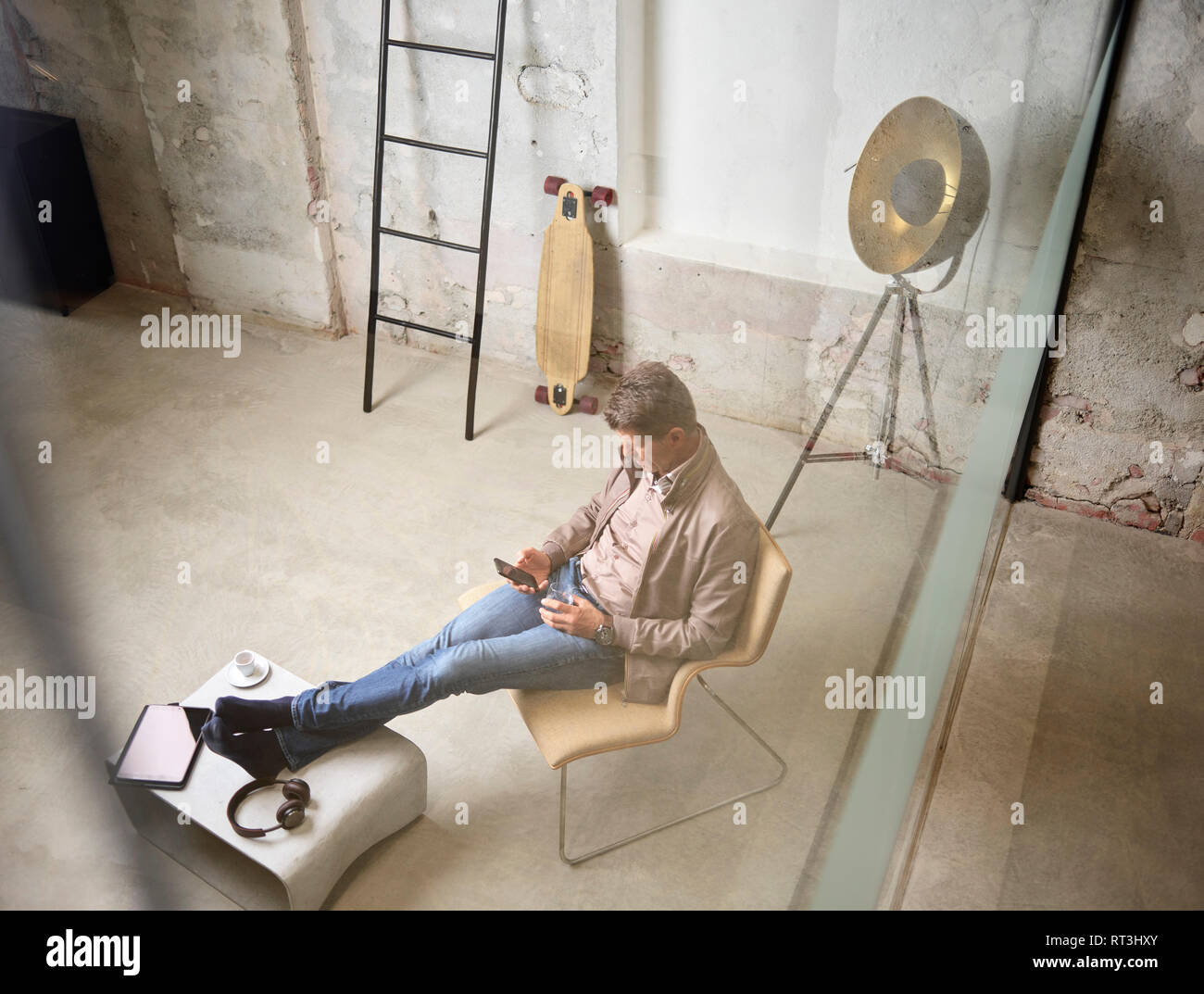 Relaxed businessman looking cell phone office lounge hi-res stock ...