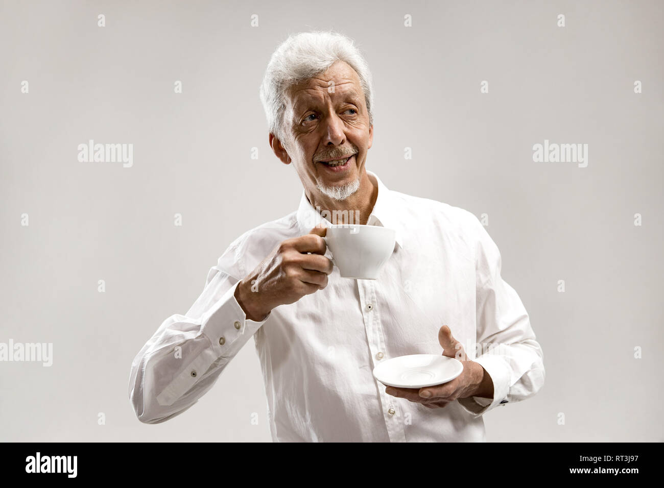 People concept - happy senior man with cup of tea at studio. Human ...