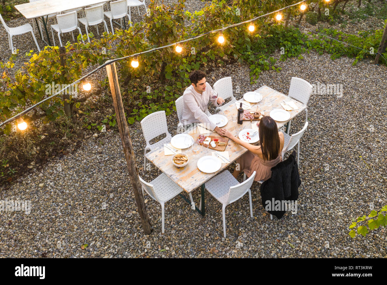 Italy, Tuscany, Siena, young couple having a romantic dinner in a ...