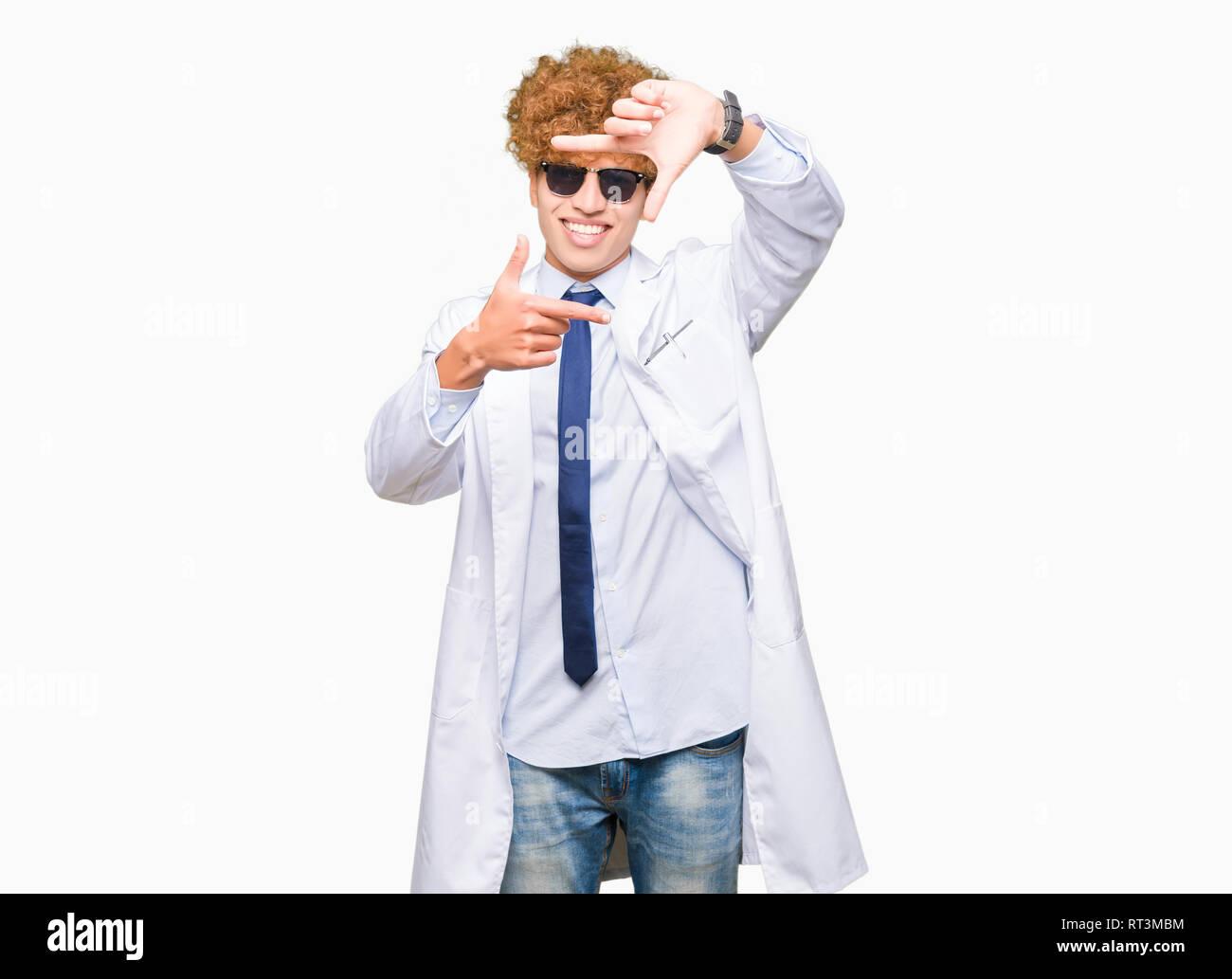 Young handsome scientist man wearing professional coat and sunglasses ...