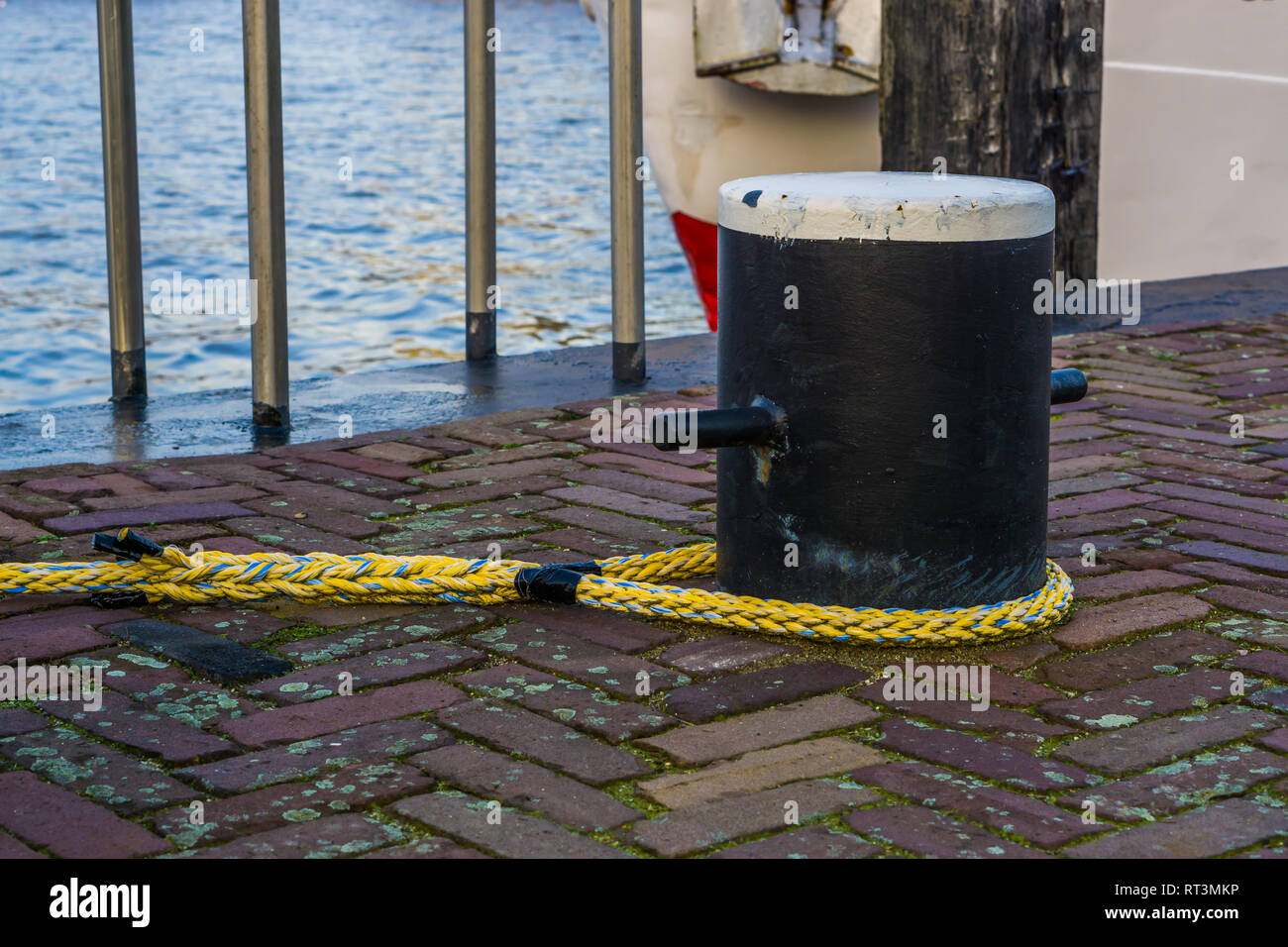 Docking pole with a rope to secure the boat, equipment at the harbor ...