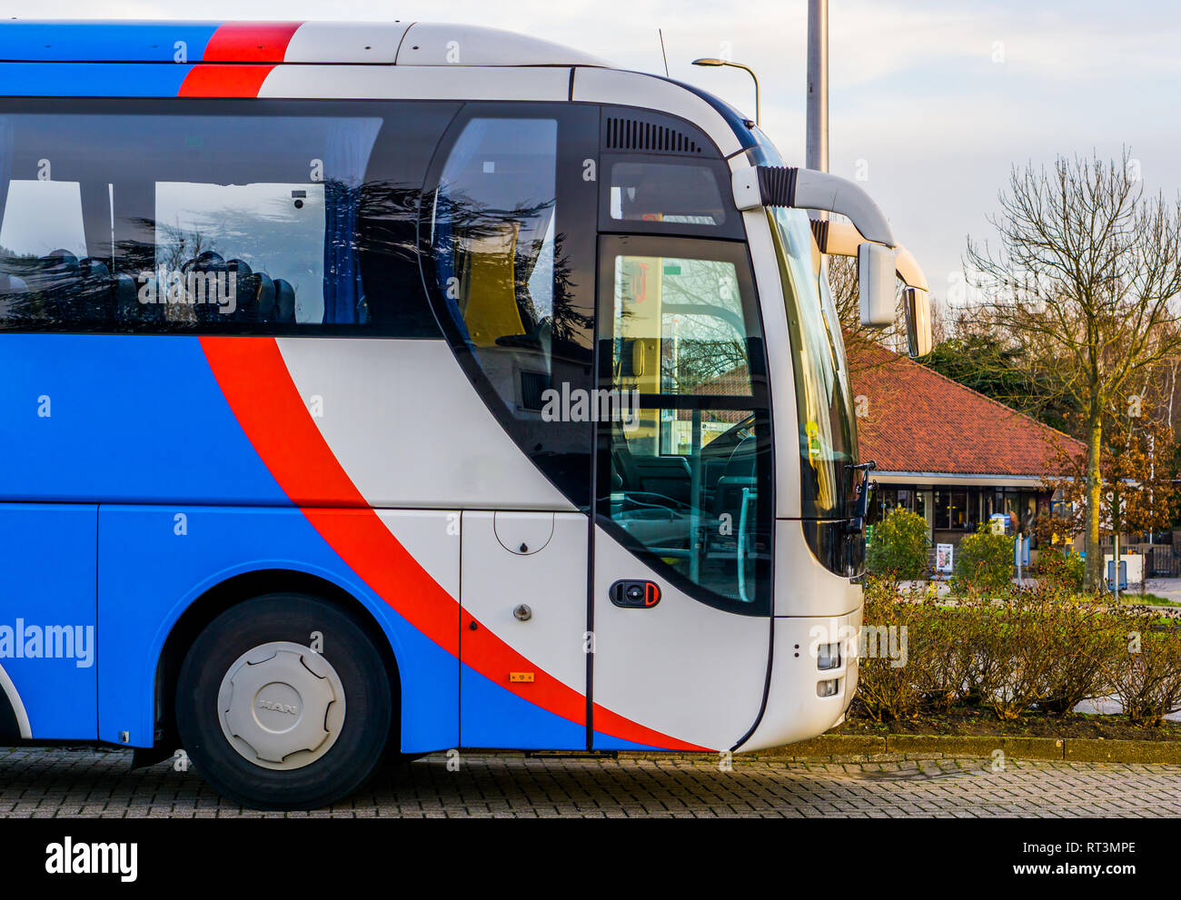 the cabin of a white, red and blue modern tour bus, transport for the ...