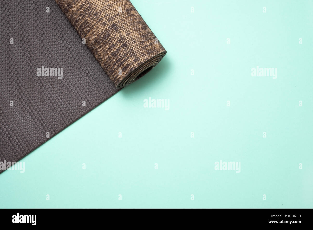 New yoga mat on a colored blue background. Top View with copy space ...