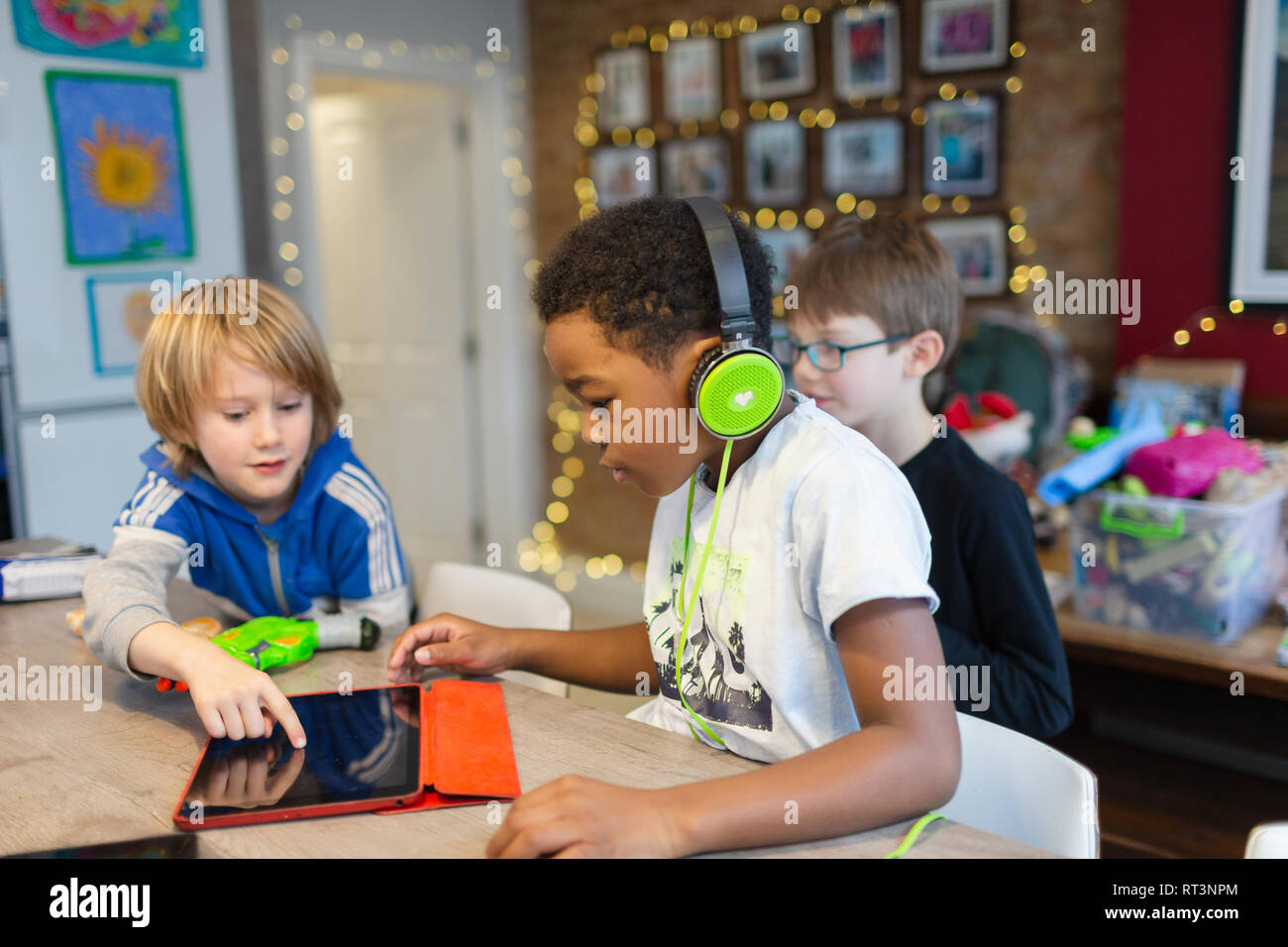 Boys playing video game with digital tablet Stock Photo - Alamy