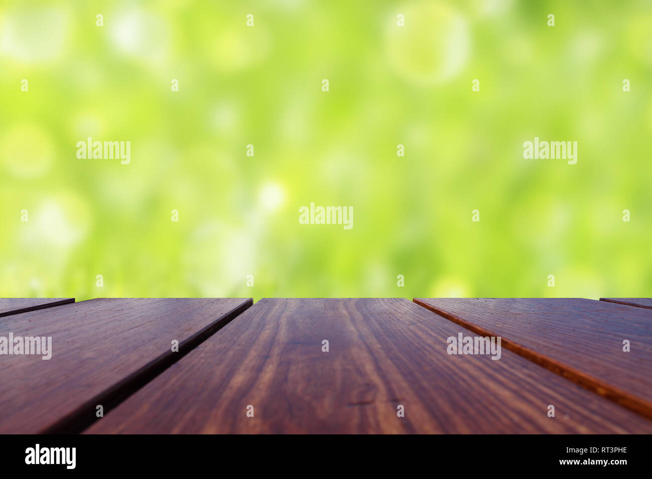 Wood Table Top with Bright Green Background Stock Photo - Alamy