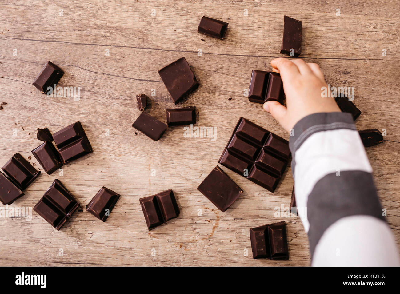 Kids hand taking chocolate hi-res stock photography and images - Alamy