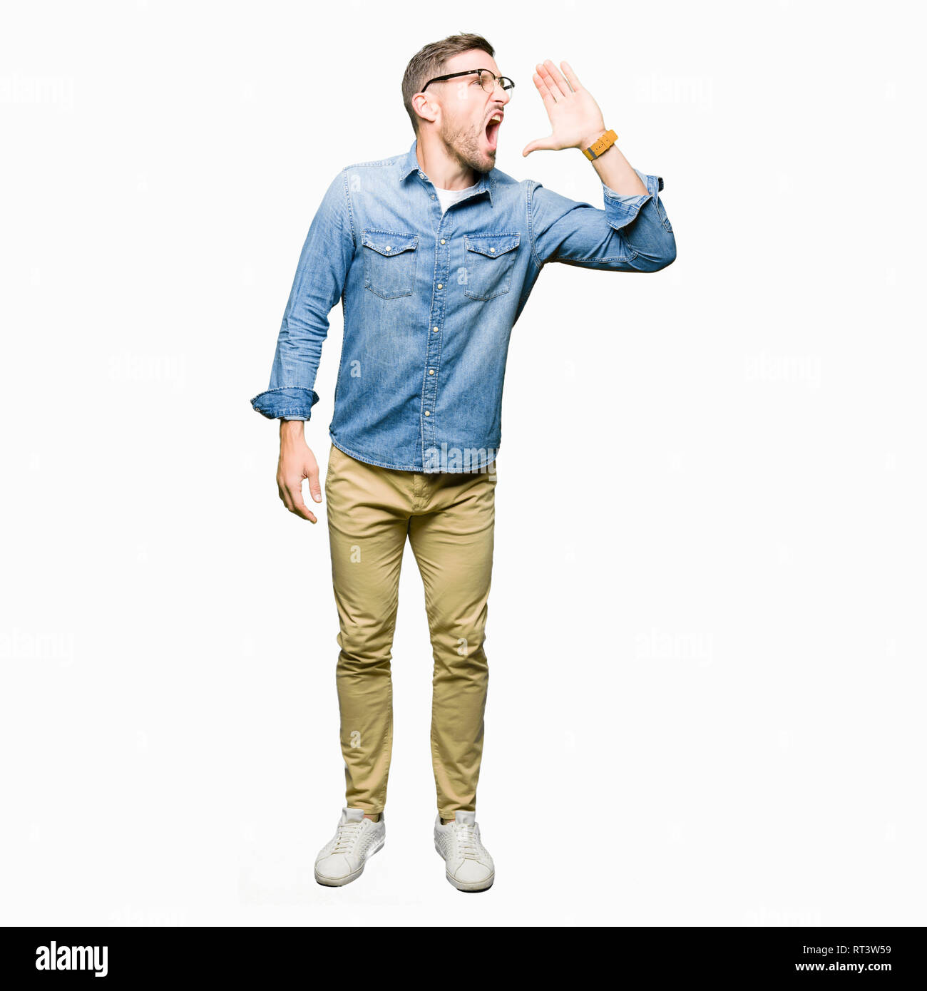 Handsome man wearing glasses shouting and screaming loud to side with ...